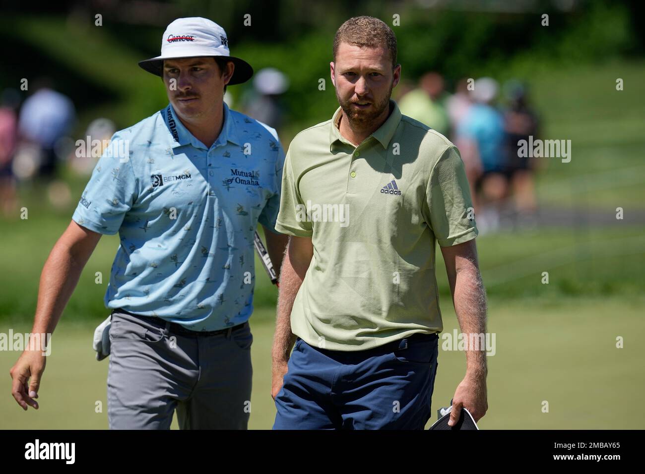 Joel Dahmen, left, and Daniel Berger leave the 18th green during the ...