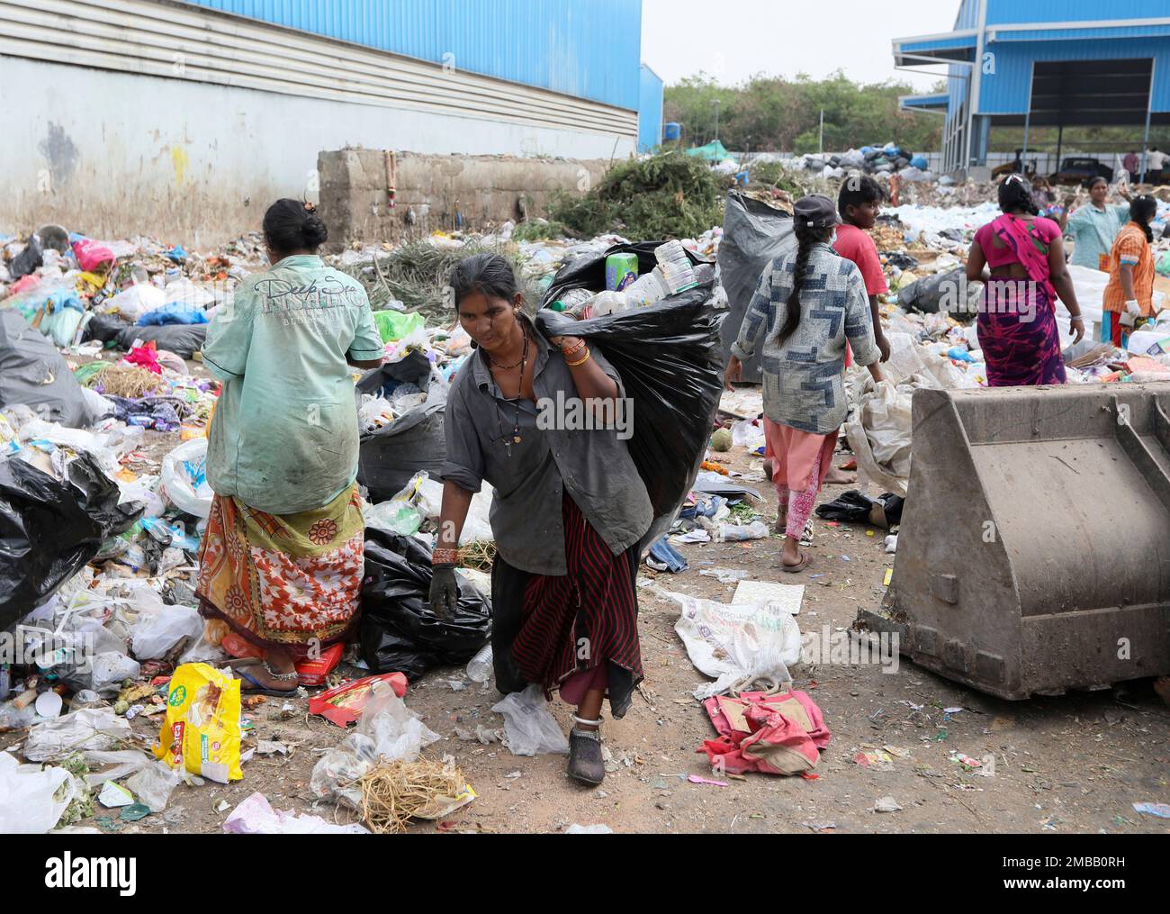 Ragpickers collect reusable material at a garbage dump in Hyderabad ...