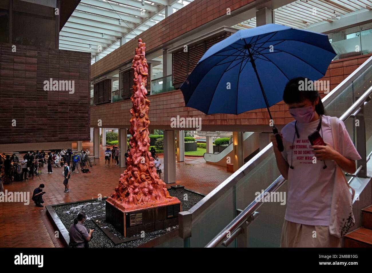 FILE - A woman walks in front of the "Pillar of Shame" statue, a ...