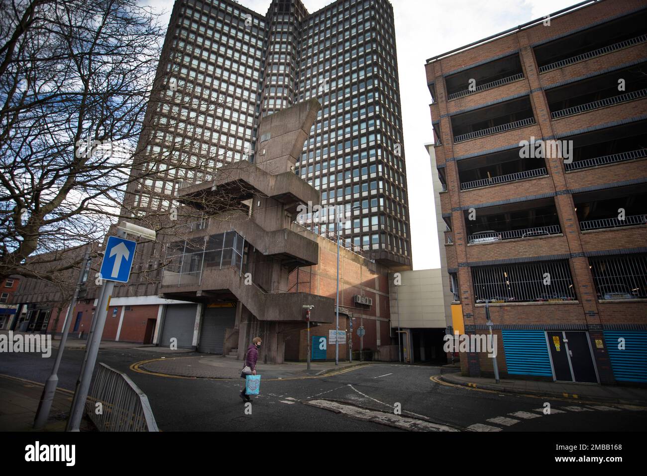 A woman crossing a back street the town of Bootle, Sefton, which ...