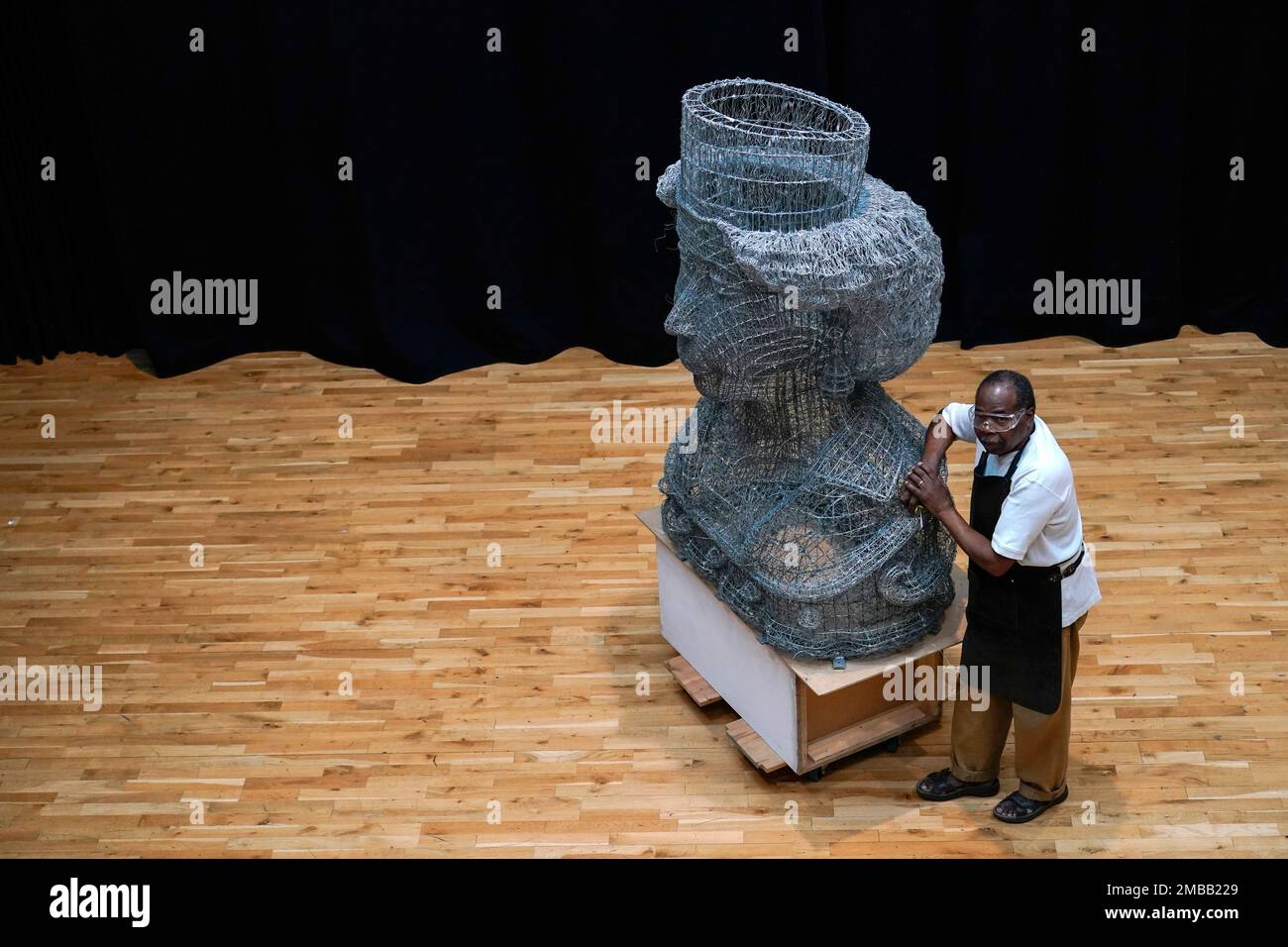 Artist Carl Gabriel in his studio stands next to his sculpture made of ...