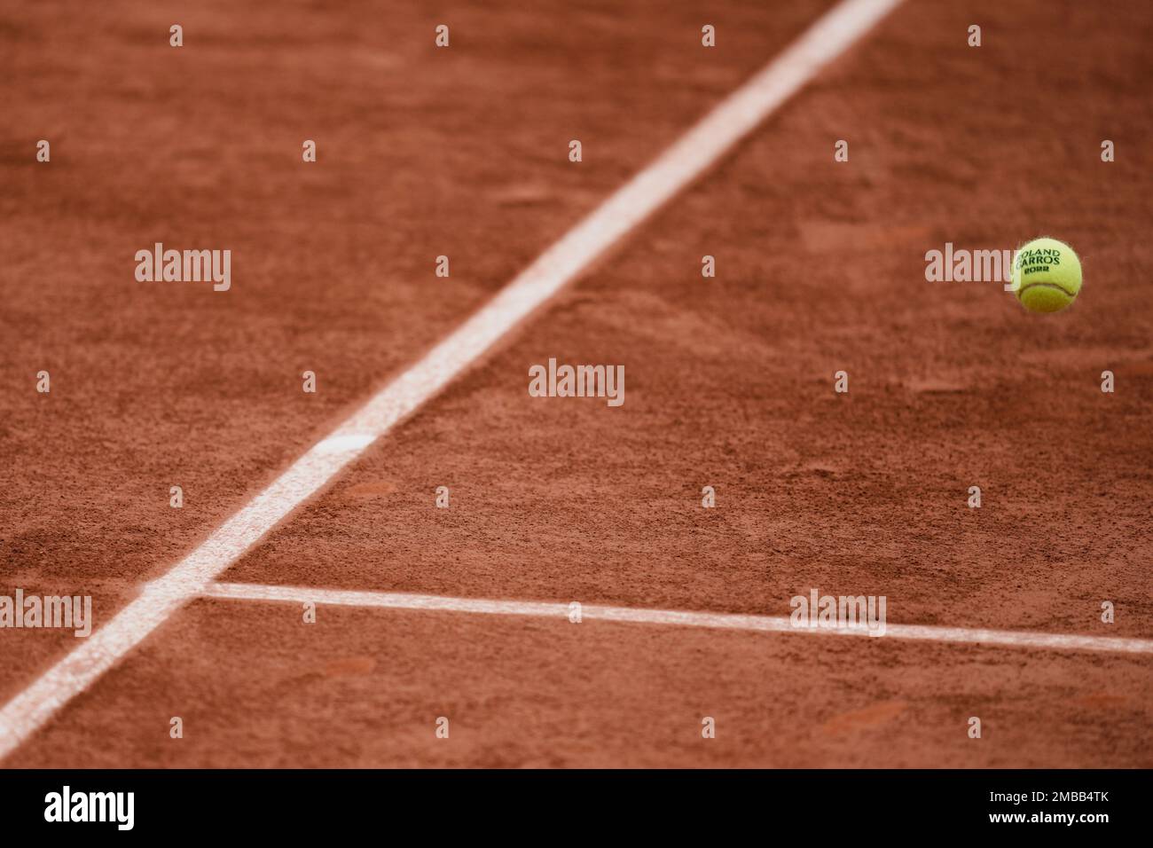 FILE - A Roland Garros 2022 ball flies over the clay court during a ...