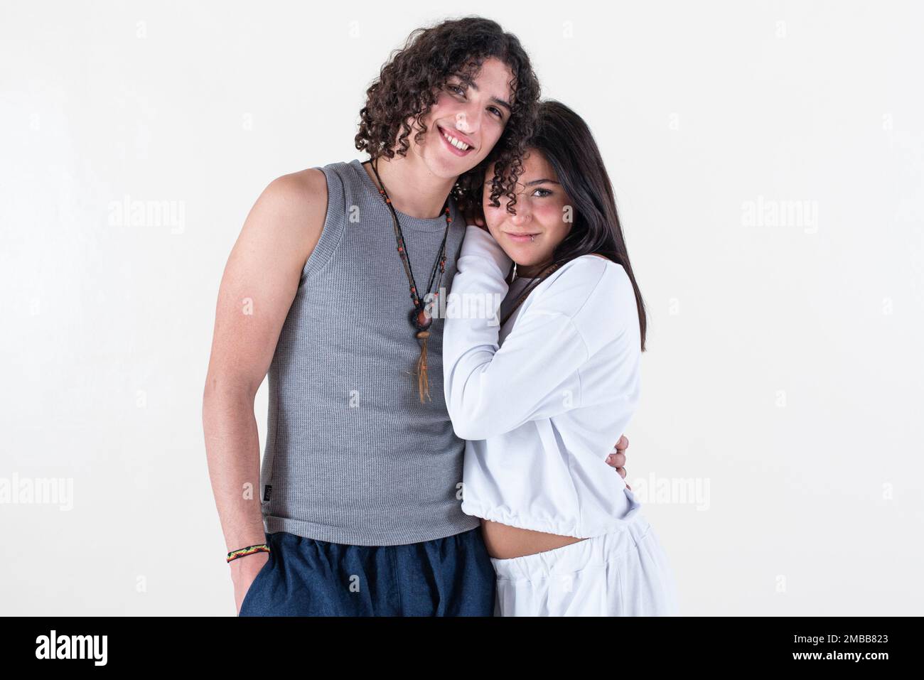 Portrait of a young couple dressed in yoga clothes looking ti the ...