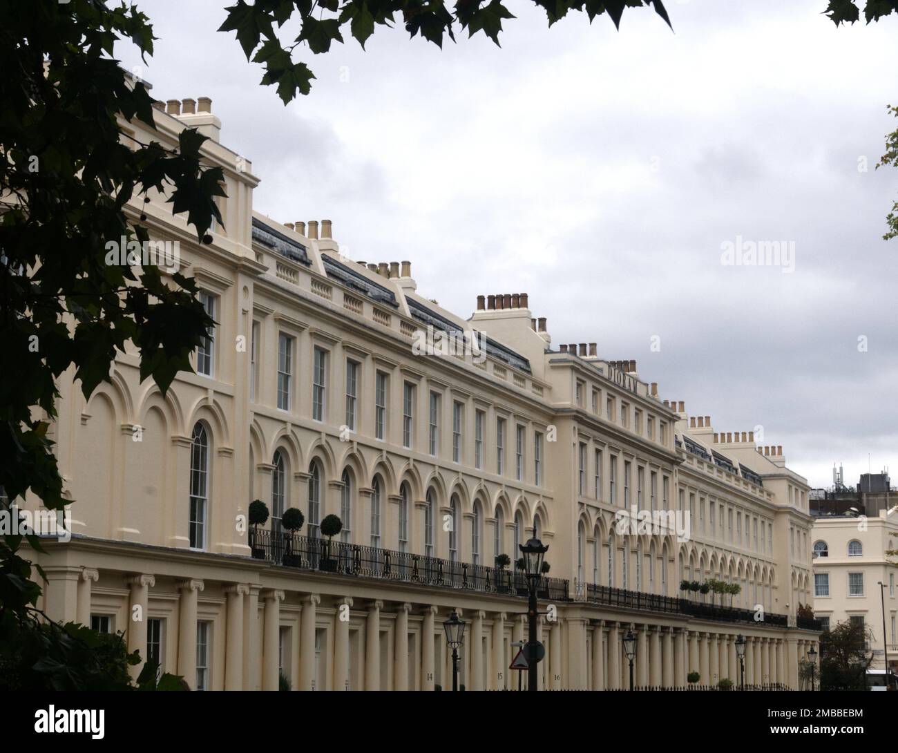 White classic buildings with sky and leaves Stock Photo - Alamy