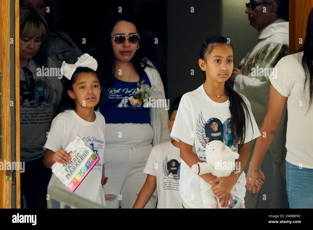 Family and friends follow the casket of Jose Flores Jr. after a funeral ...