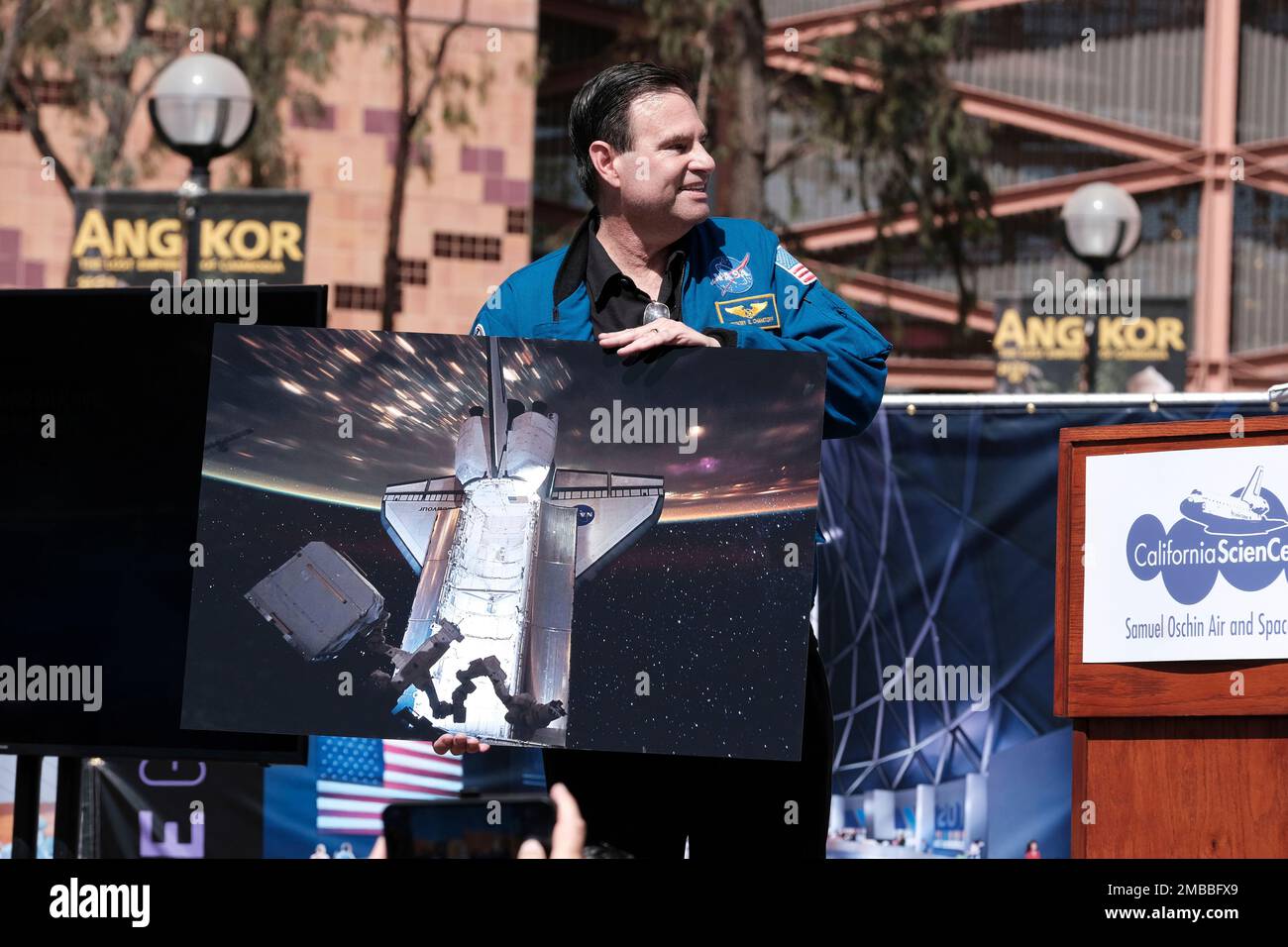 Former NASA astronaut Gregory E. Chamitoff, shows a photo he took of ...