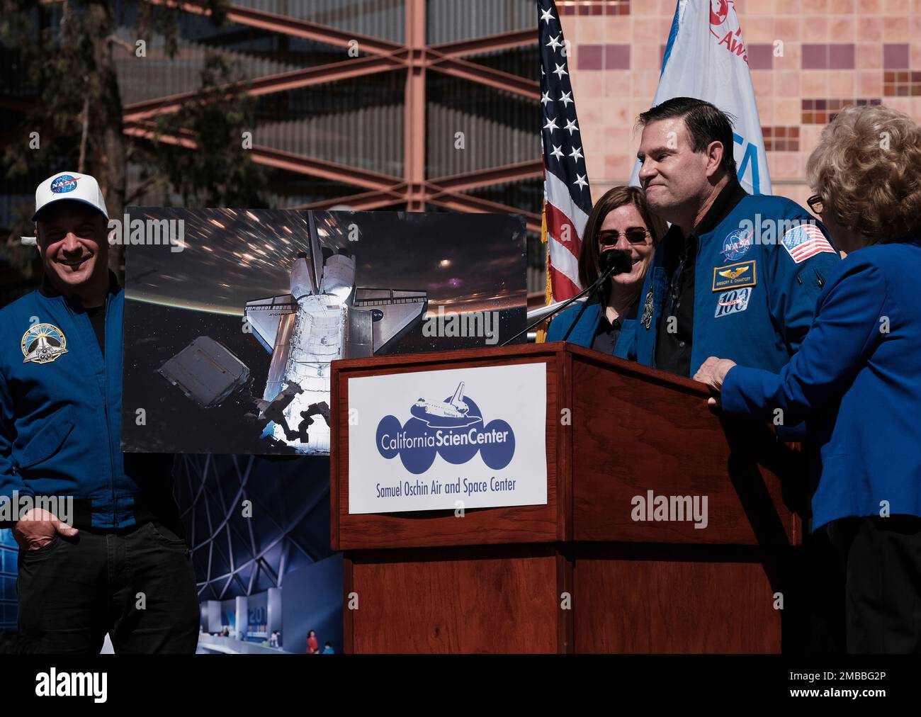 Former NASA astronaut Gregory E. Chamitoff, second from right shows a photo he took of the Space ...