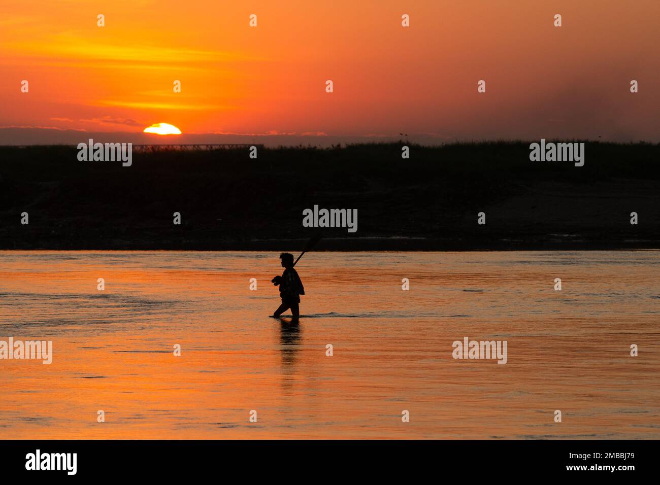 Man Walks in Front of Setting Sun Walking in Water. Beautiful ...