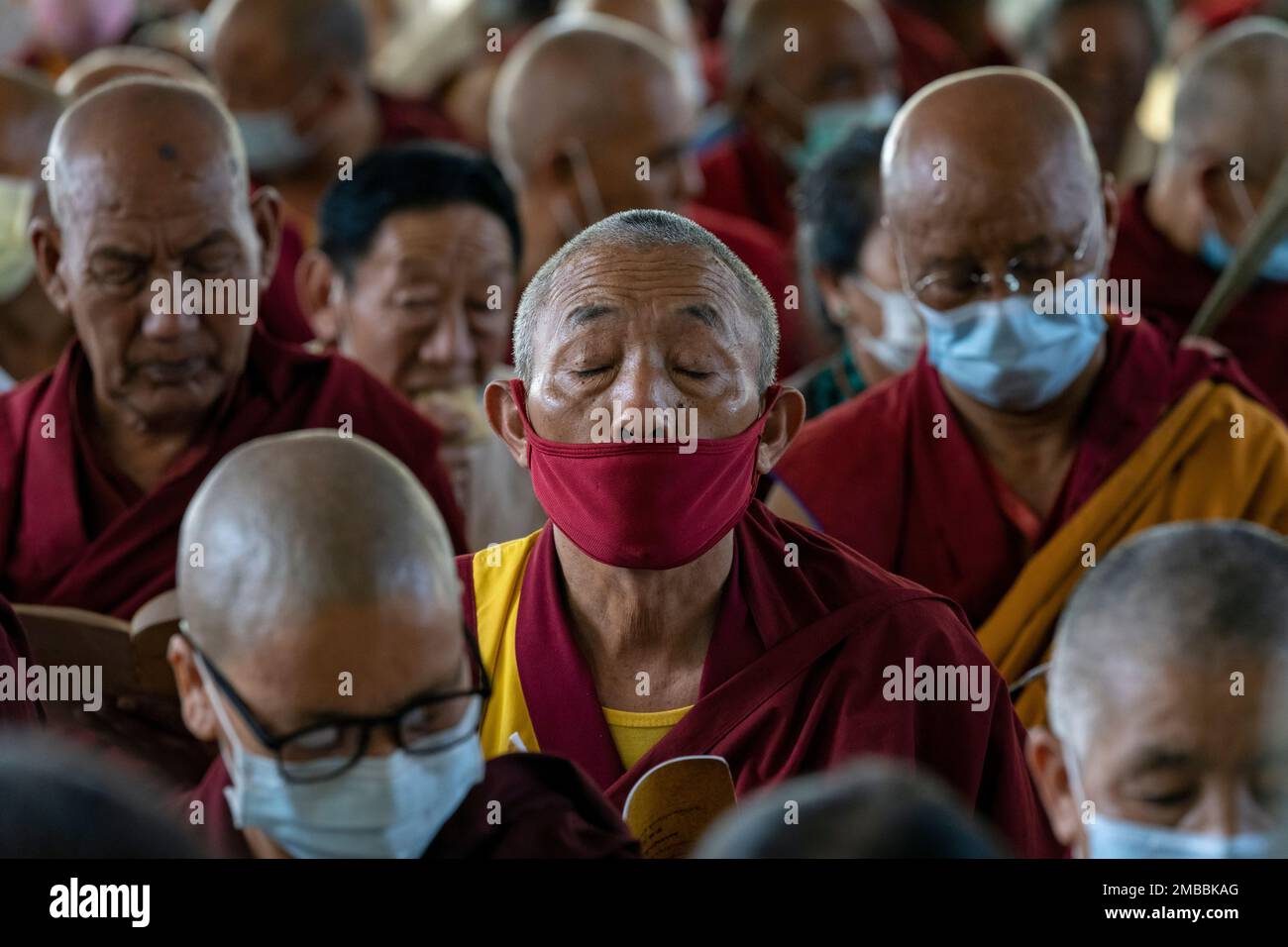 An exile Tibetan Buddhist monk prays as he listens to his spiritual ...