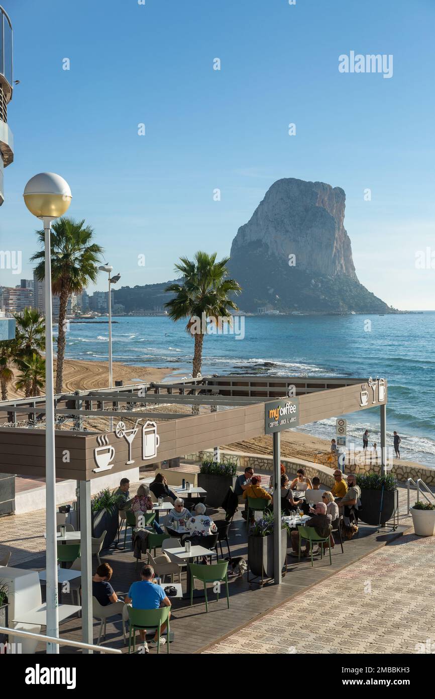 Beach and seafront promenade at Calpe, Spain. Penon de Ifach in ...