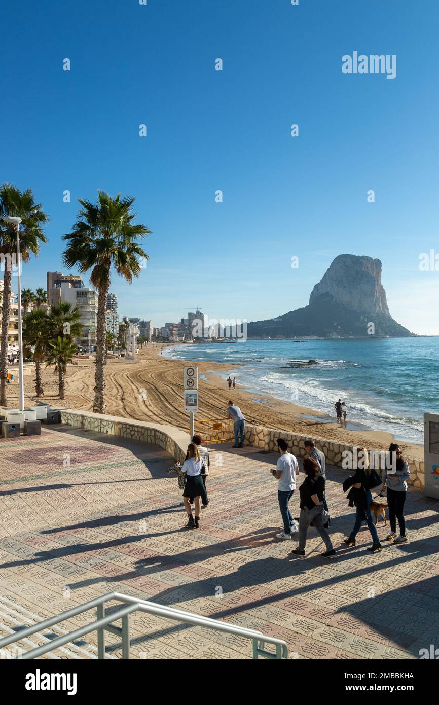 Beach and seafront promenade at Calpe, Spain. Penon de Ifach in ...