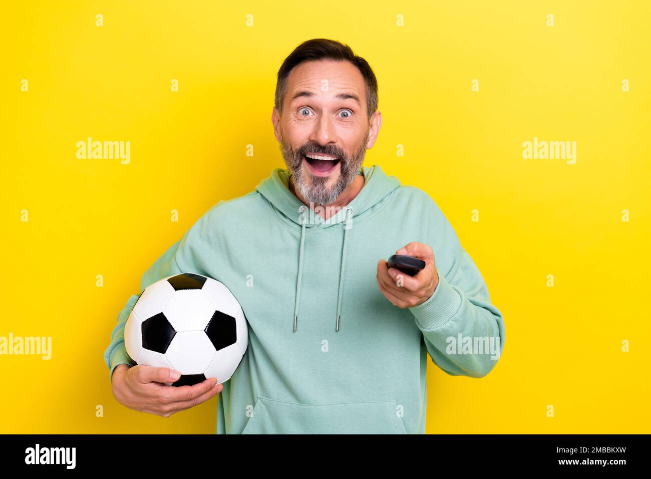 Photo of funky cheerful overjoyed big football fan watch tv world cup ...