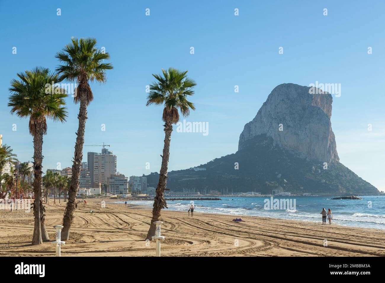 Beach and seafront promenade at Calpe, Spain. Penon de Ifach in ...