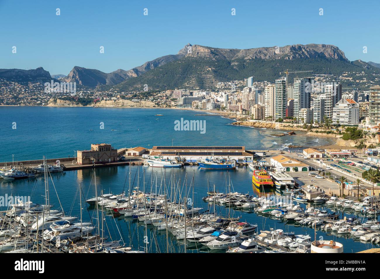 The beautiful town of Calpe and it's harbour with the hill Sierra de ...