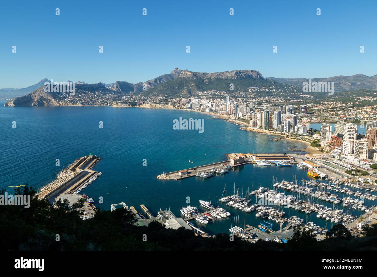 The beautiful town of Calpe and it's harbour with the hill Sierra de ...