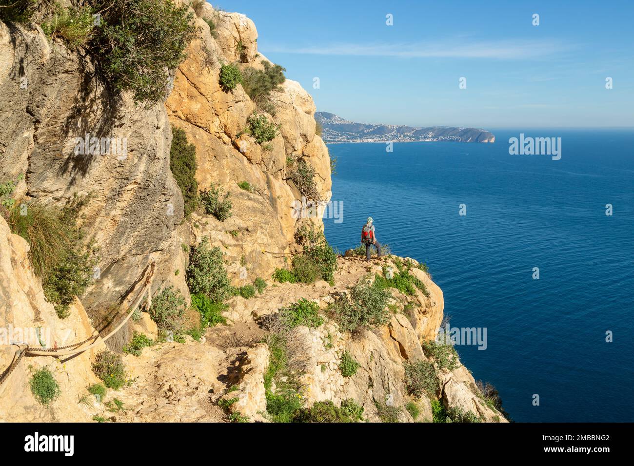 A walker on the footpath to Penon de Ifach, Calpe, Alicante province ...