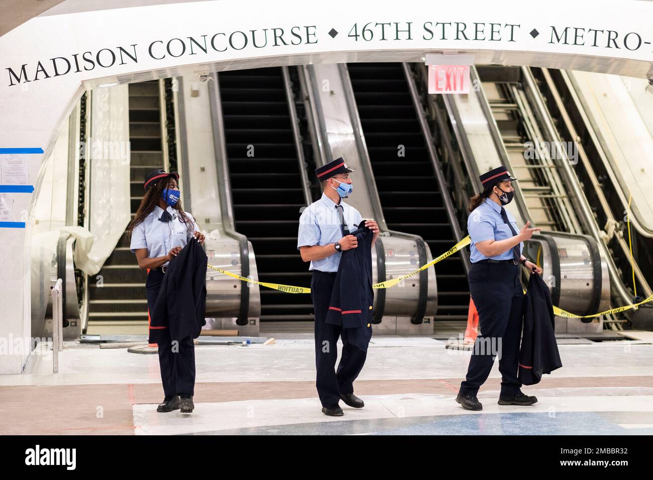 MTA train conductors walk along a promenade as construction continues ...