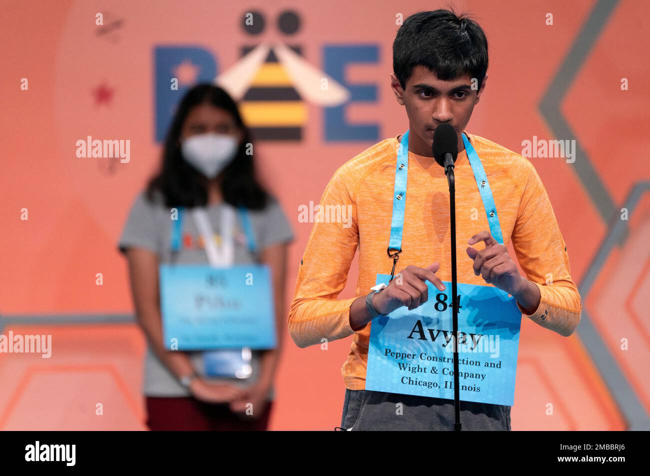 Avyay Kodali, 13, from Palatine, Ill., right, types out his word in the ...