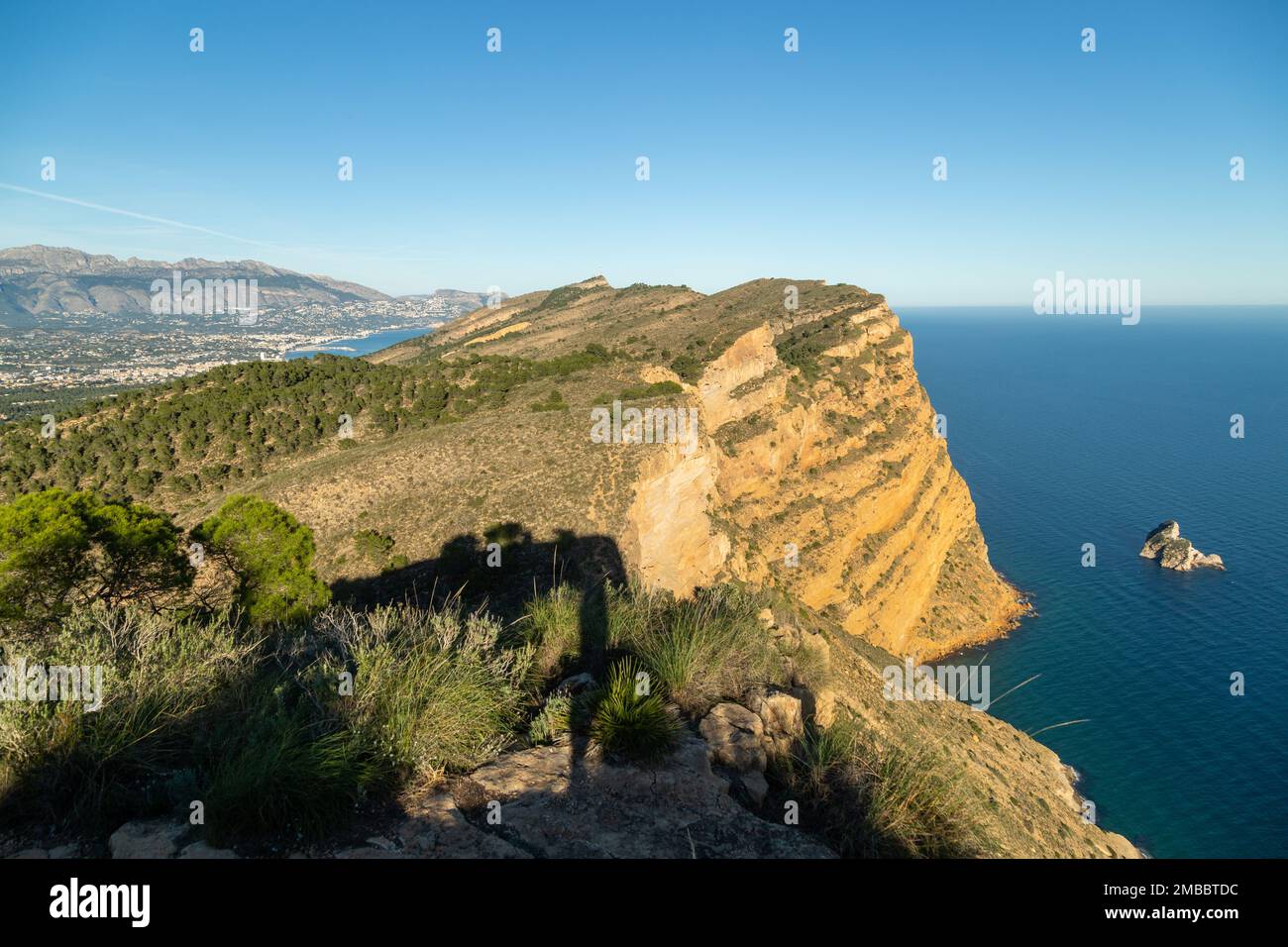Steep cliffs in the Sierra Helada natural park with the small island of ...