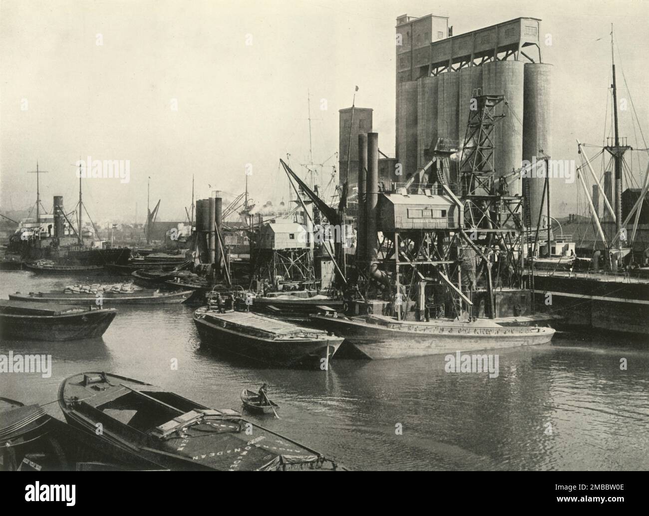 "Factories, Refineries, Granaries Grow Thick" Ship Discharging Grain by ...
