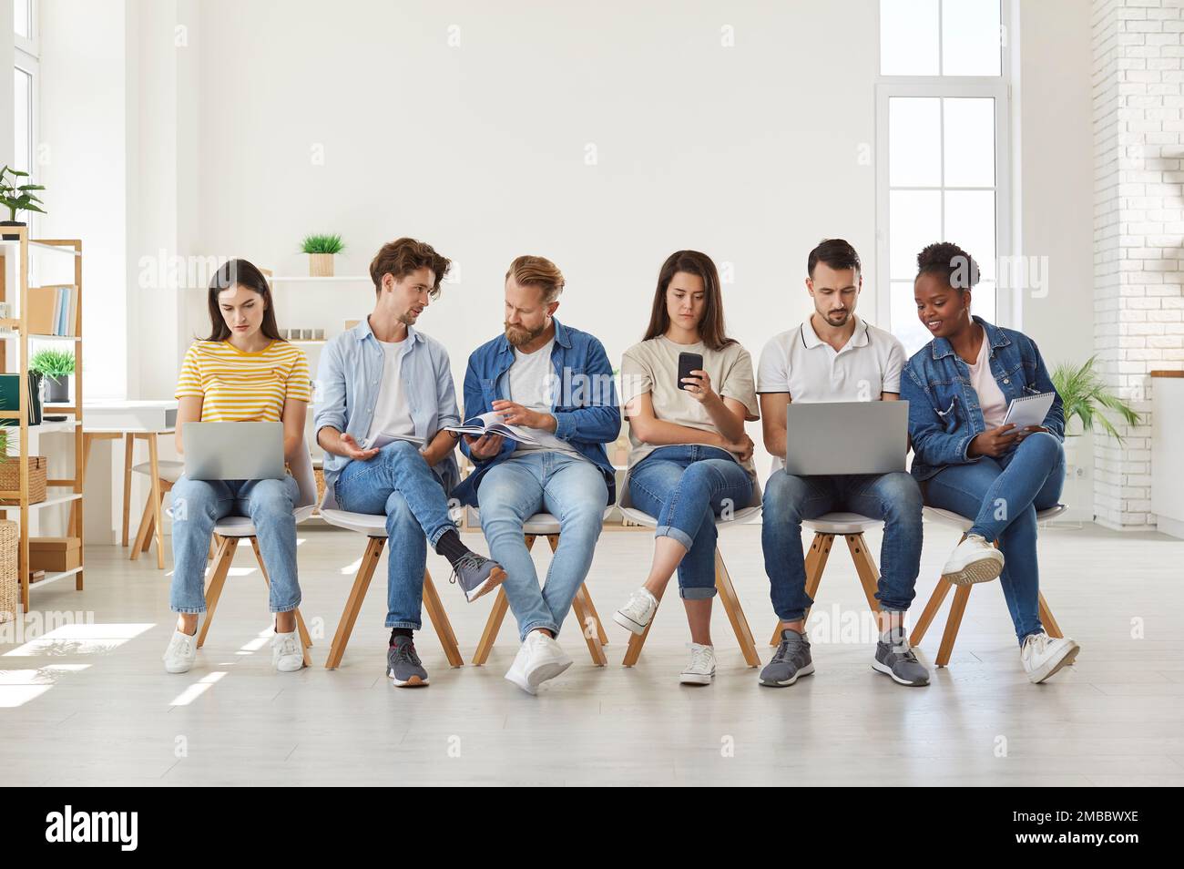 Group of students using modern digital devices at meeting Stock Photo ...