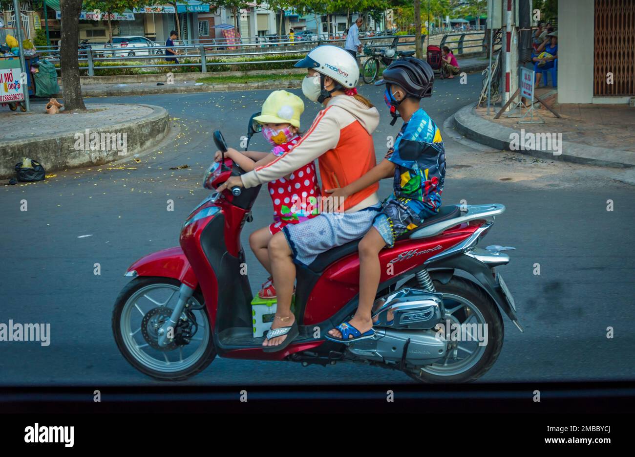 Father with two 2 sons riding a Moped in asia vietnam Stock Photo - Alamy
