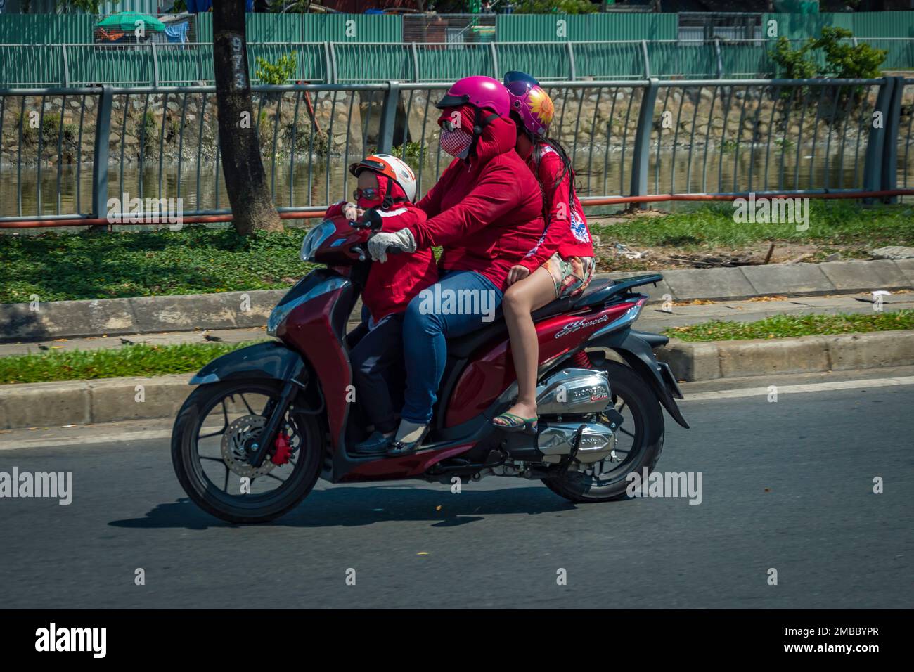 A family riding a Moped in asia vietnam Stock Photo - Alamy