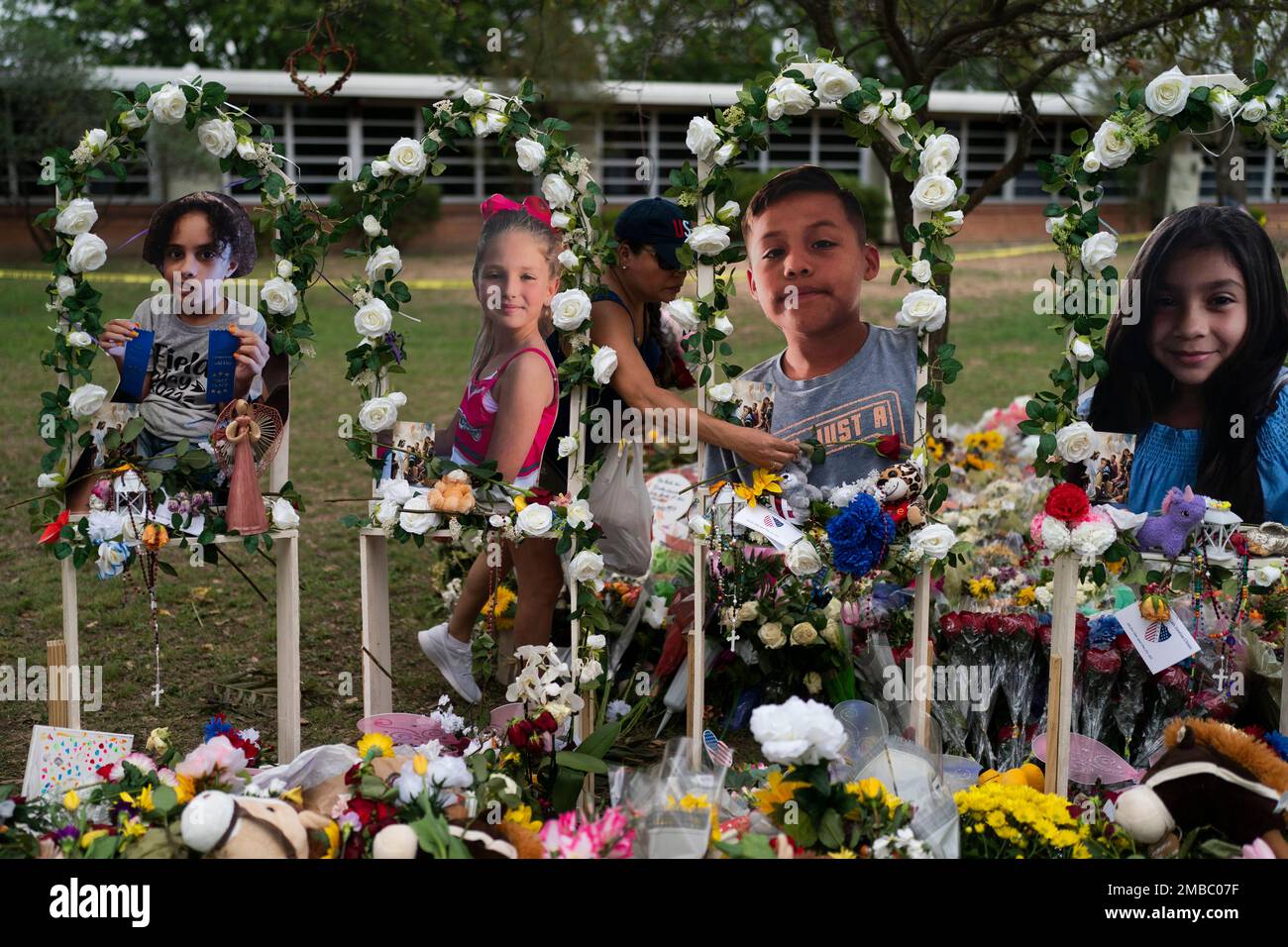 Cat Perez, 39, lays flowers at a memorial at Robb Elementary School in ...