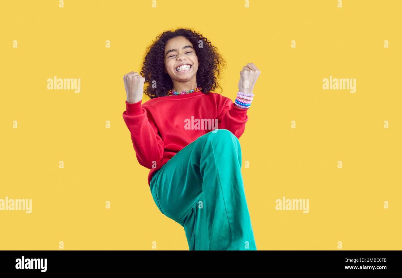Happy cute Afro American kid celebrating success, feeling excited and ...