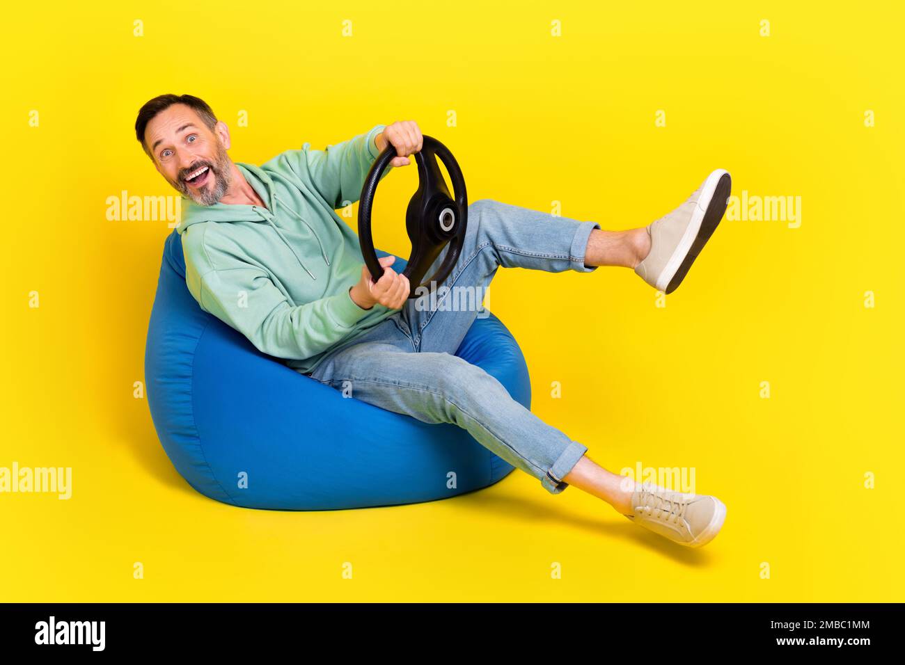 Full length photo of funny excited man wear green sweatshirt driving ...