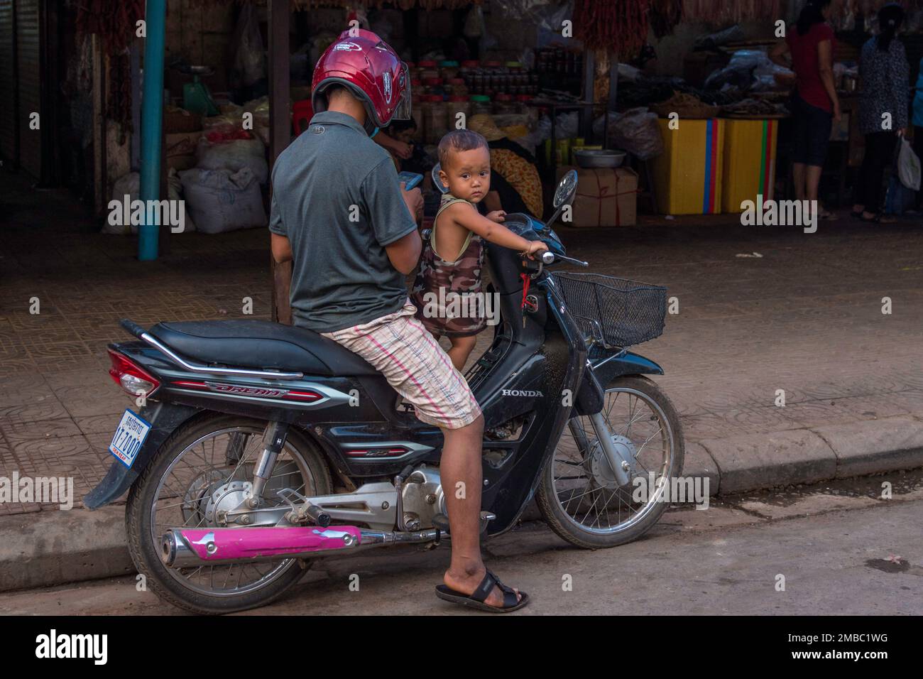 Father and son riding a Moped in asia vietnam Stock Photo - Alamy