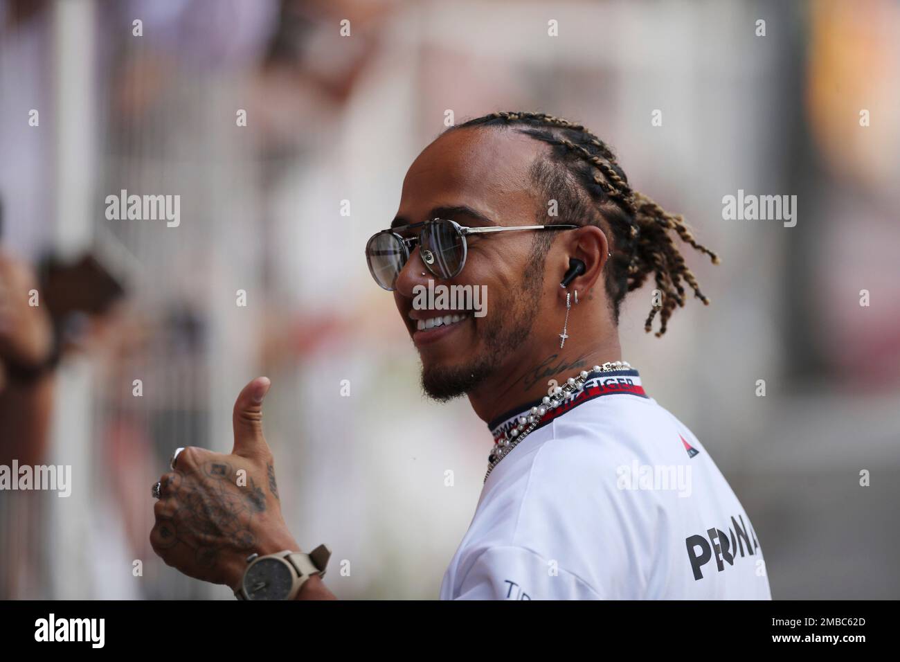 Mercedes driver Lewis Hamilton of Britain thumbs up as he arrives for ...