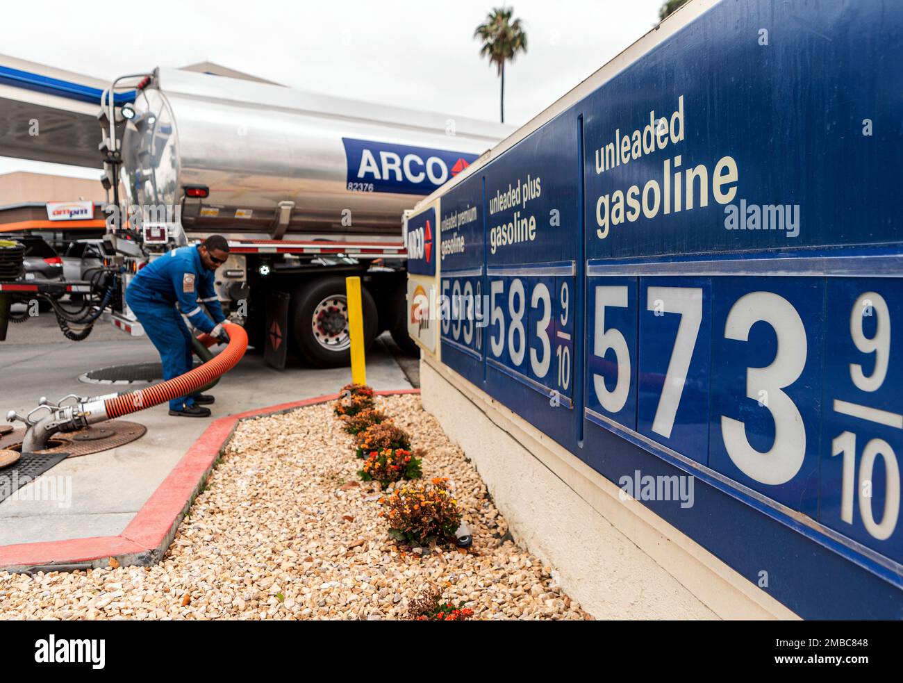 A gas tank driver delivers 8,500 gallons of gasoline at an ARCO gas ...