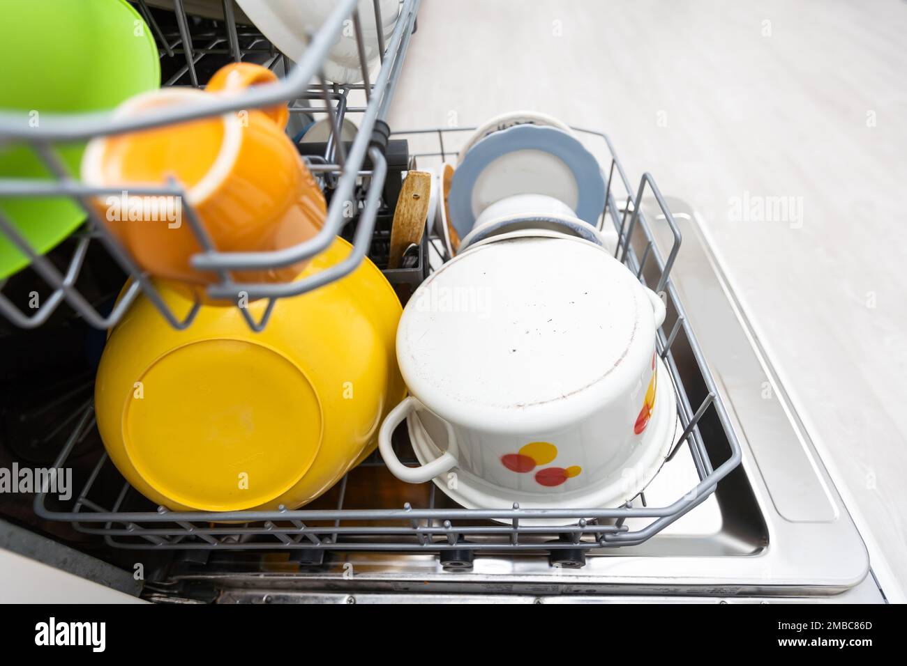 Dishes and cutlery on dishwashing machine. Clean dishes Stock Photo - Alamy