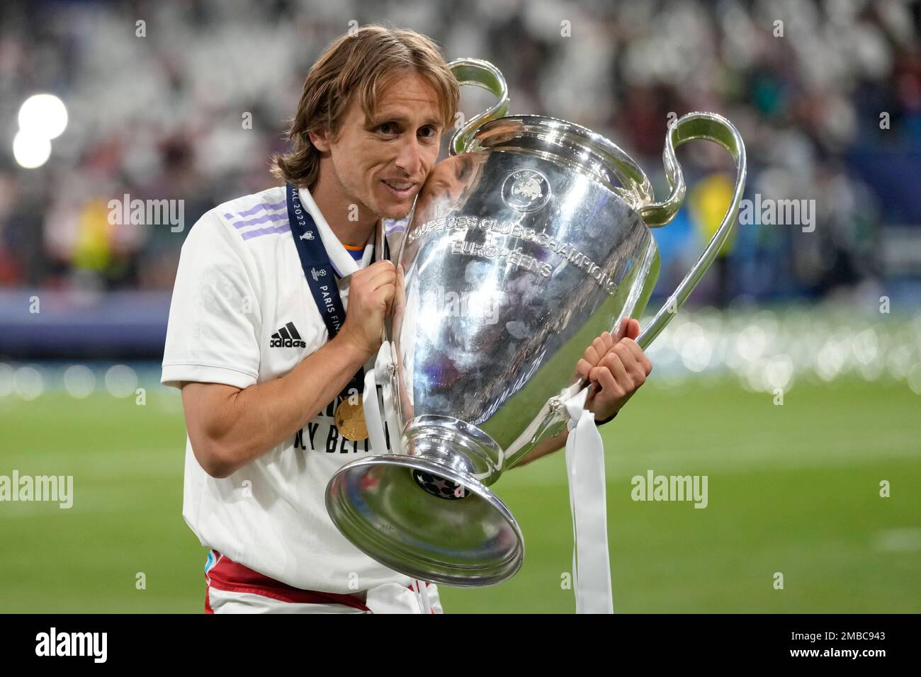 Real Madrid's Luka Modric holds the trophy as pose for a photograph ...