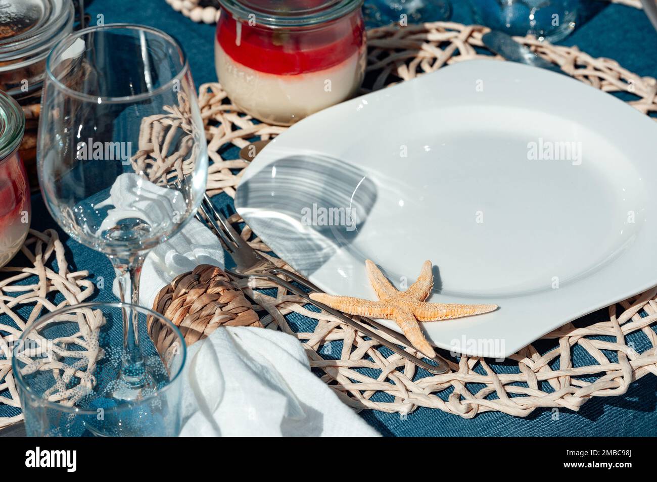 Beautiful table setting with plate, white napkin, braided decorative ...