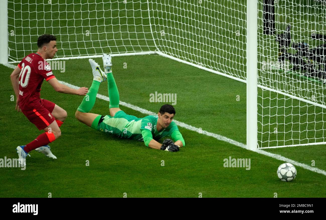 Real Madrid's goalkeeper Thibaut Courtois, right, makes a save in front ...