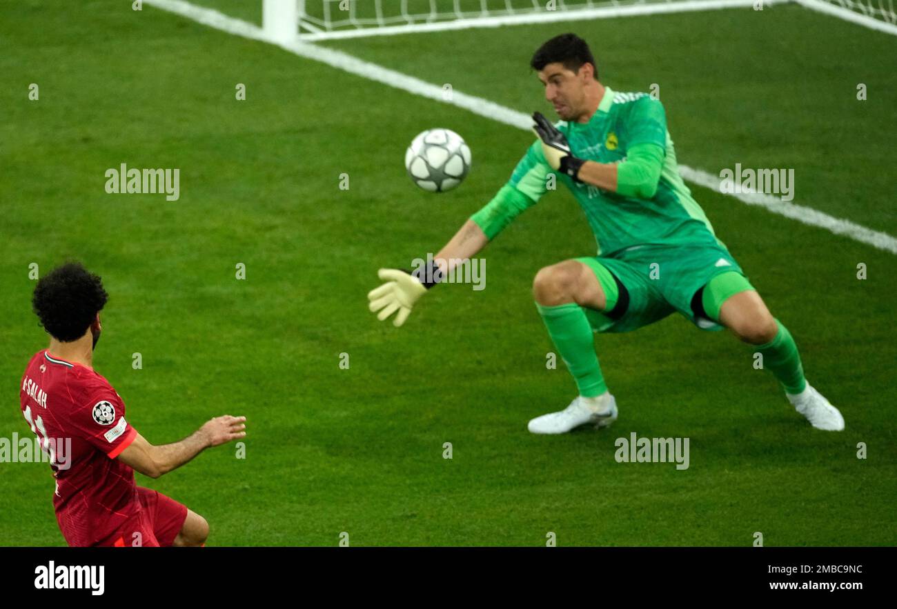 Real Madrid's goalkeeper Thibaut Courtois, right, makes a save in front ...