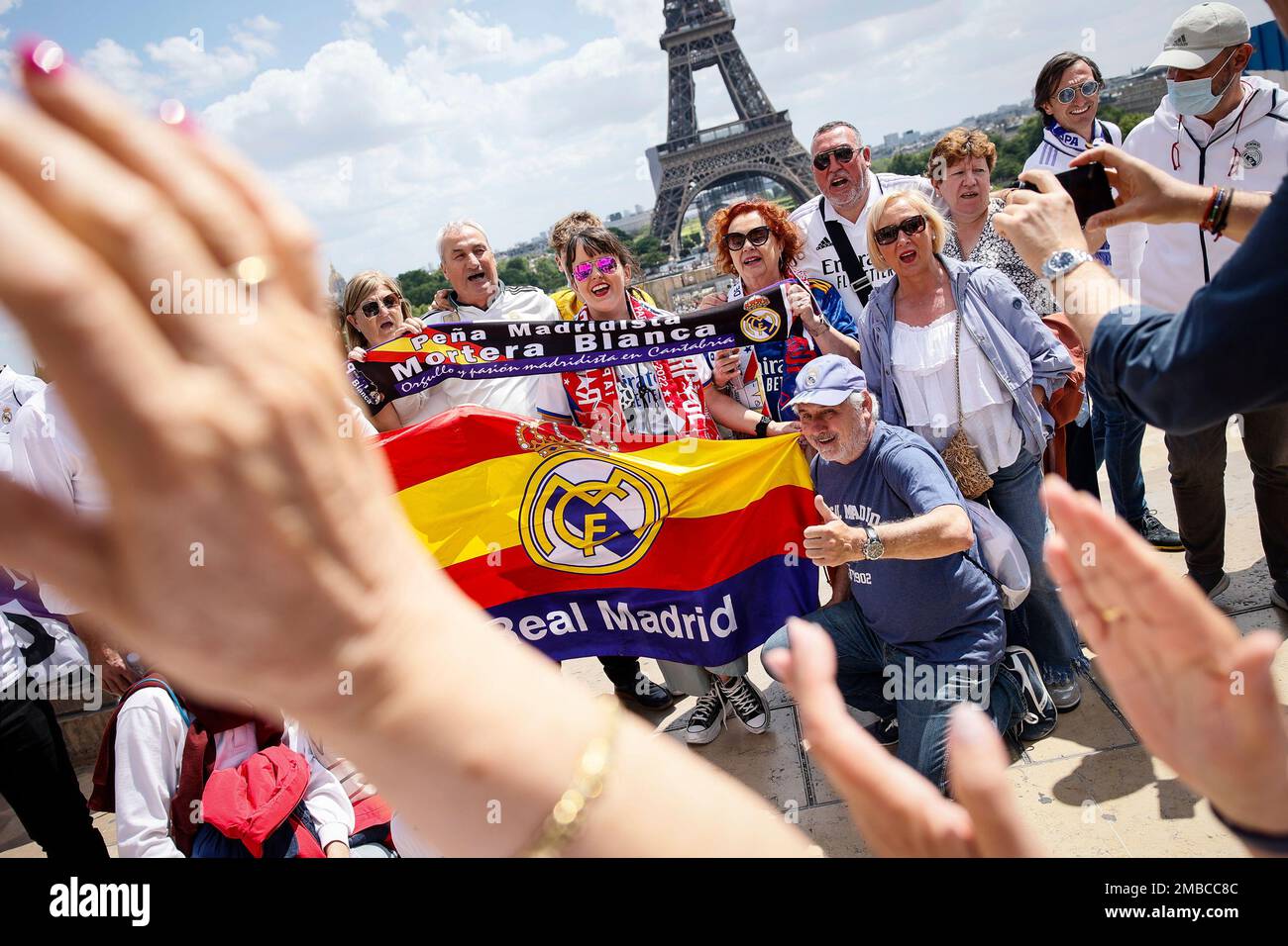 Real Madrid supporters pose in front of the Eiffel Tower in Paris ...