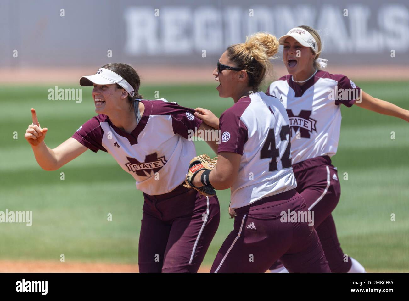 Mississippi State infielder Madisyn Kennedy, left, celebrates after she ...