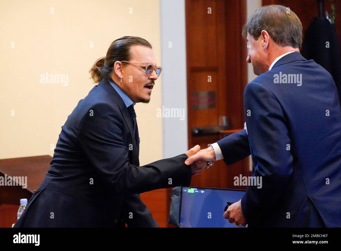 Actor Johnny Depp shakes hands with attorney Benjamin Chew as he ...