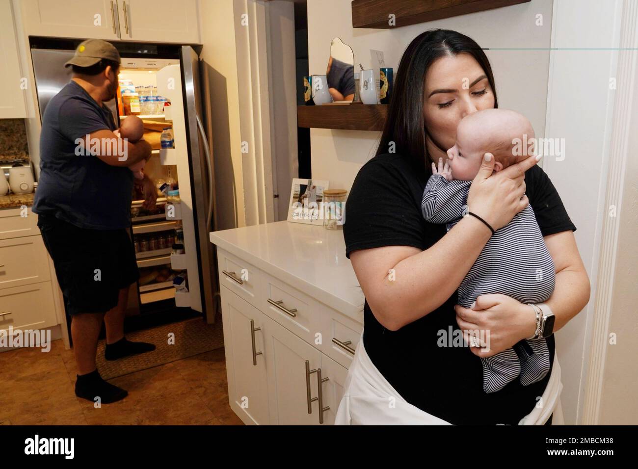 Lissette Fernandez kisses their newborn son Luca as her husband George ...