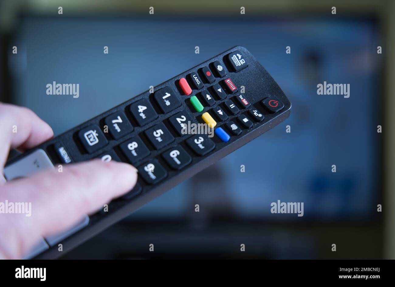 TV remote in use and held by a person Stock Photo - Alamy