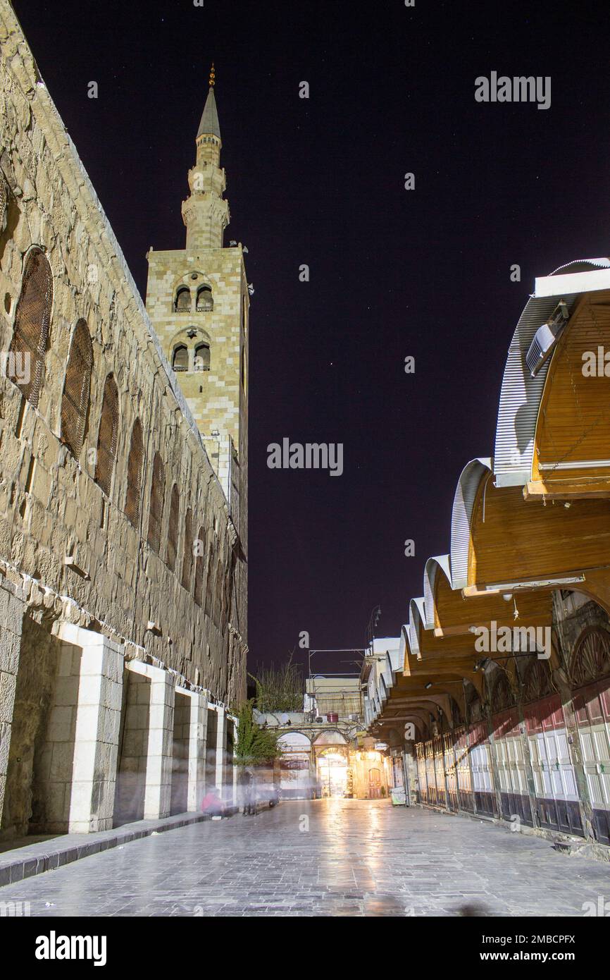 A vertical shot of the Minaret of the Great Umayyad Mosque at night in ...
