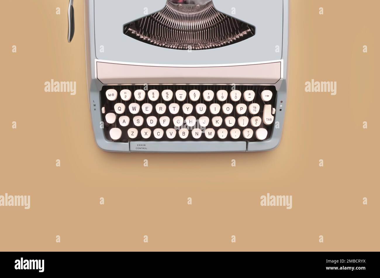Overhead top view of a vintage aqua blue typewriter against a beige ...