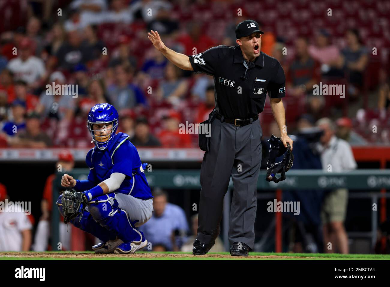 MLB umpire Dan Merzel yells to the Cubs' dugout during a baseball game ...