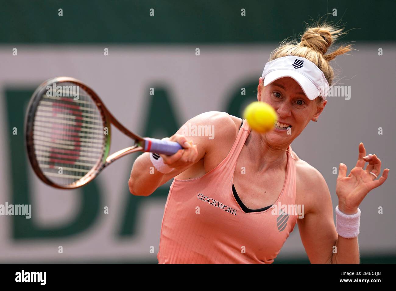Alison Riske of the U.S. returns the ball to Poland's Iga Swiatek ...