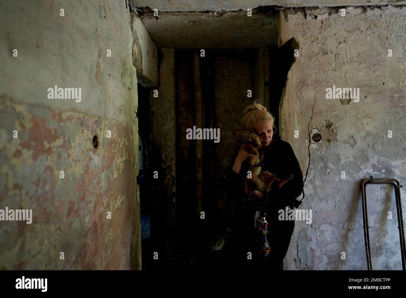 Olga Chernenko, 51 years old, holds her dog Casper, inside her home ...