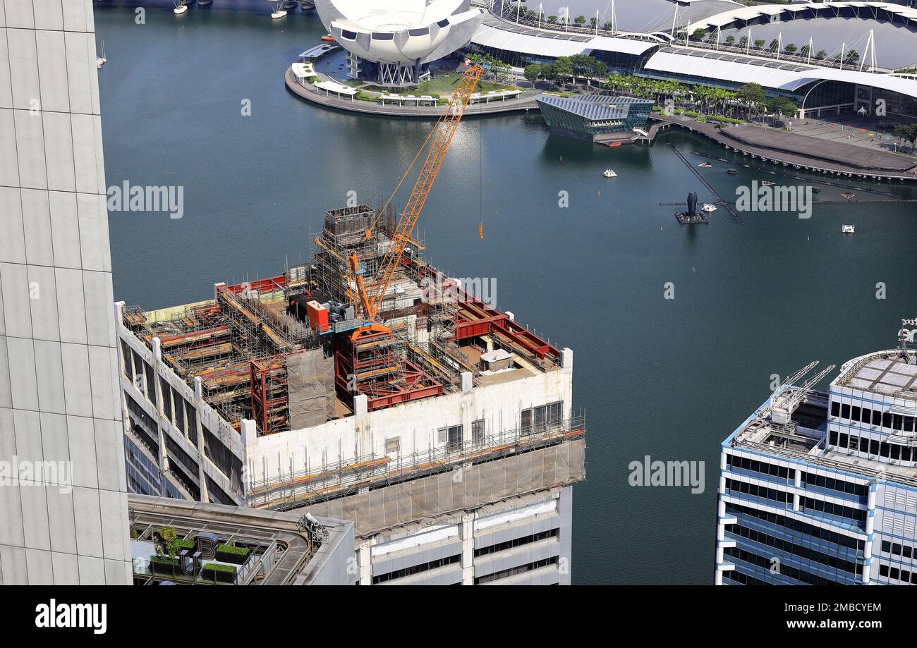 high angle shot of Yellow tower crane on top of building, used in ...