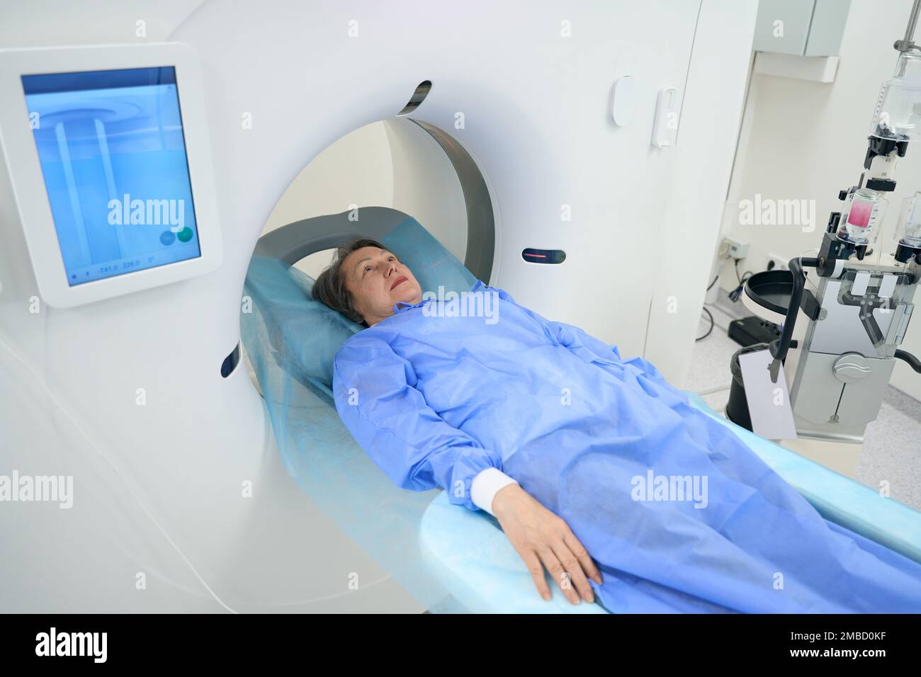 Woman undergoes CT scan procedure in diagnostic department of hospital ...